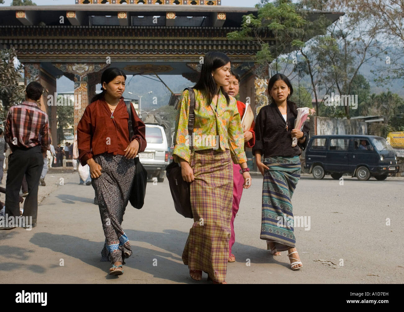 Bhutanese women walk from the border crossing point at Jaigon West ...