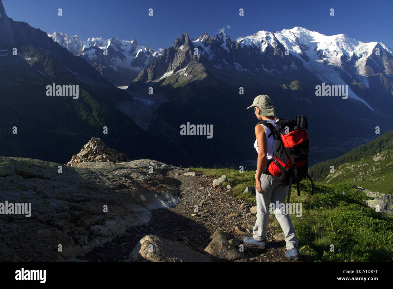 Female hiker in the French Alps, with the Mont Blanc massif in the ...