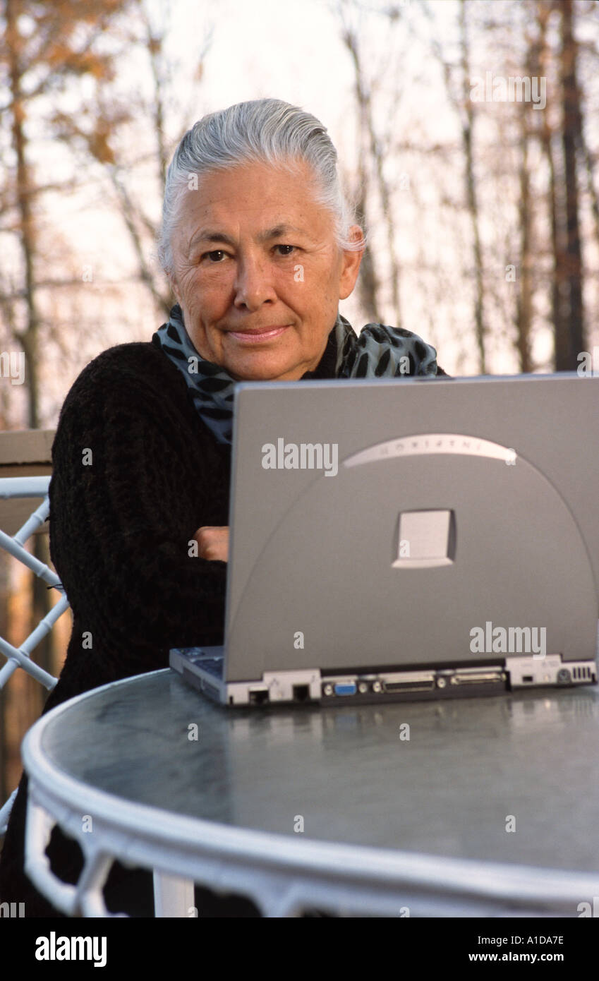 portrait of older woman looking over computer screen Stock Photo - Alamy