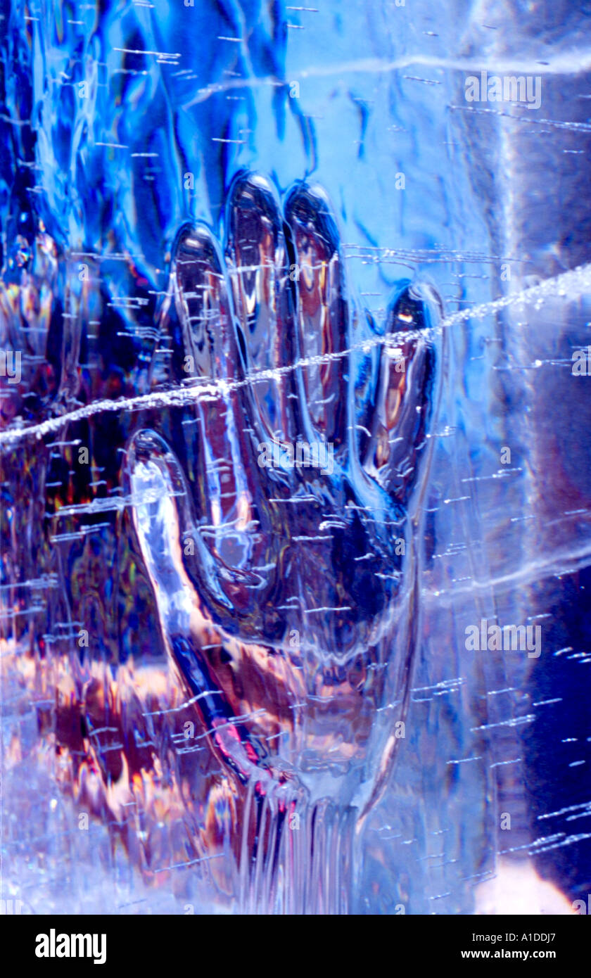 Abstract of a melting handprint on a block of ice with child spectators ...