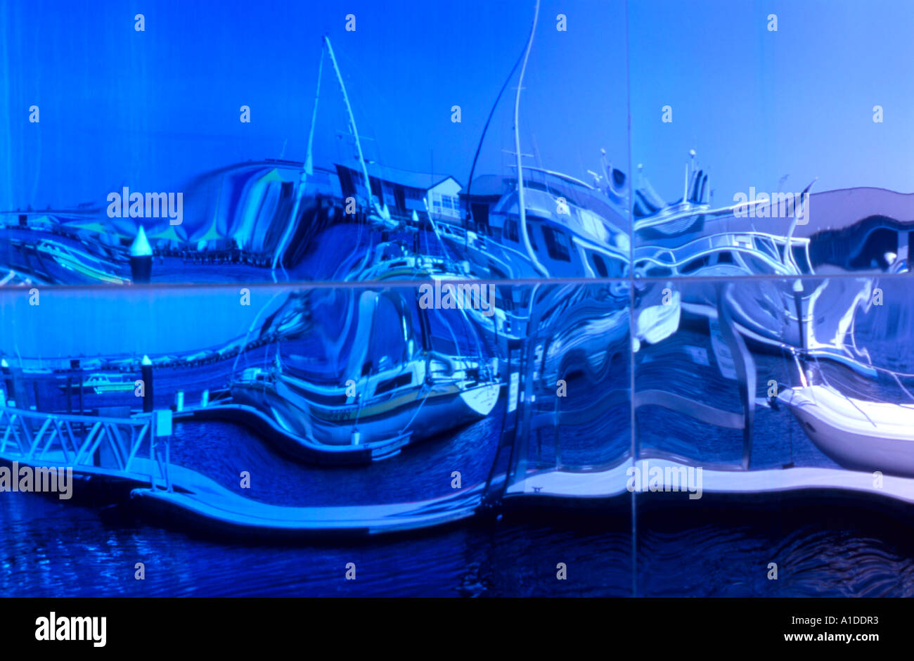 Abstract of a yacht marina reflected and distored in glass windows ...
