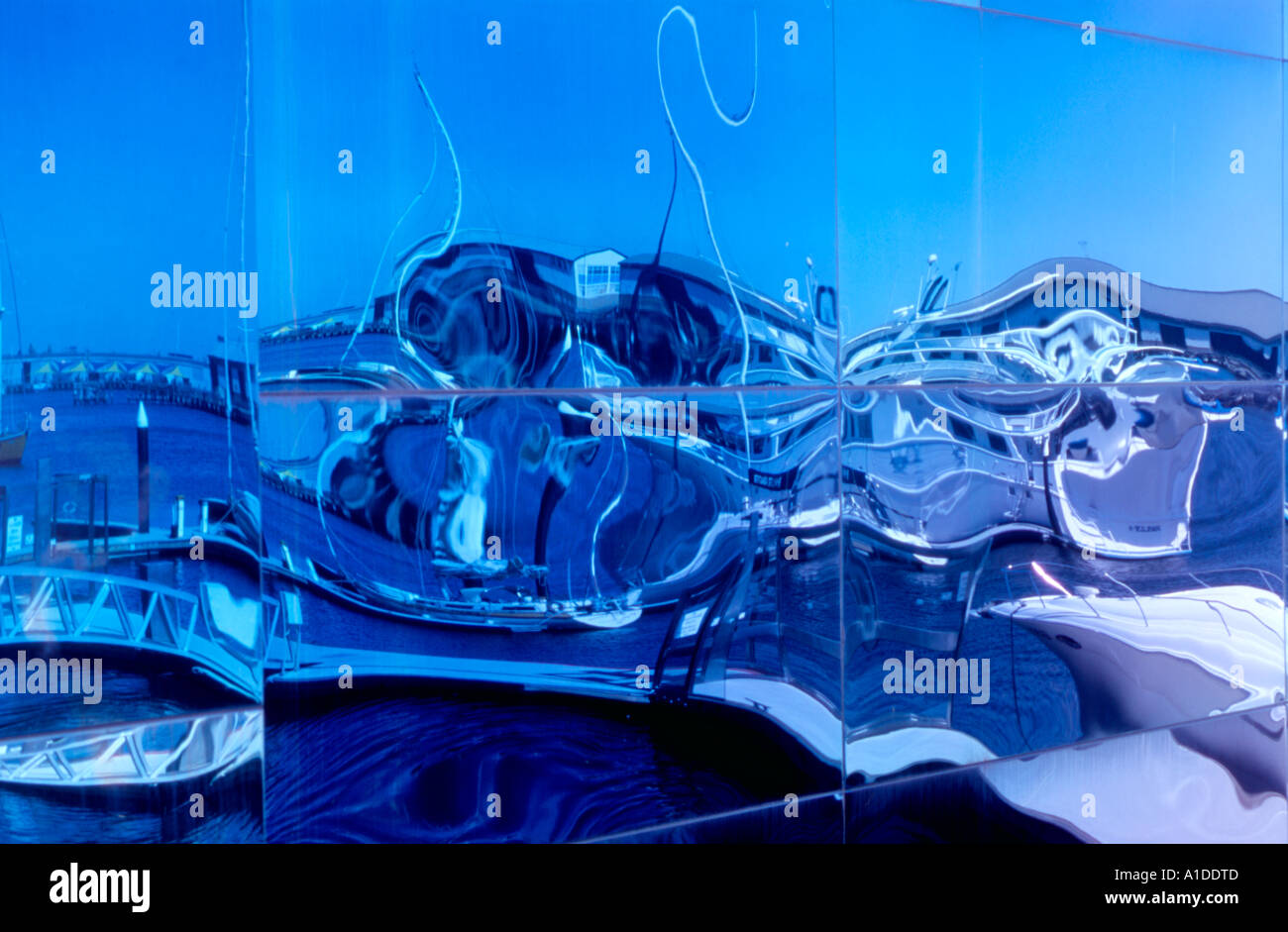 Abstract of a yacht marina reflected and distored in glass windows ...