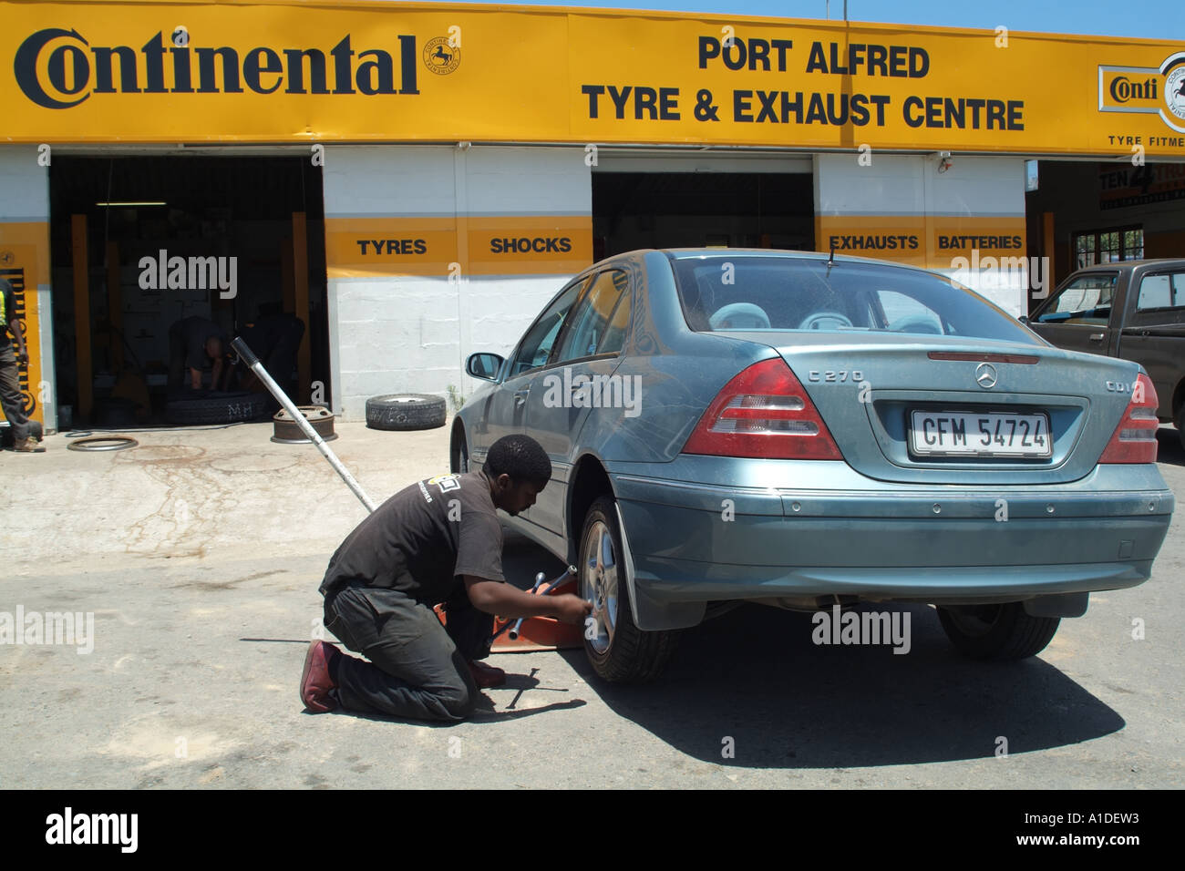 Mechanic changing car wheel after tyre change South Africa RSA Stock ...