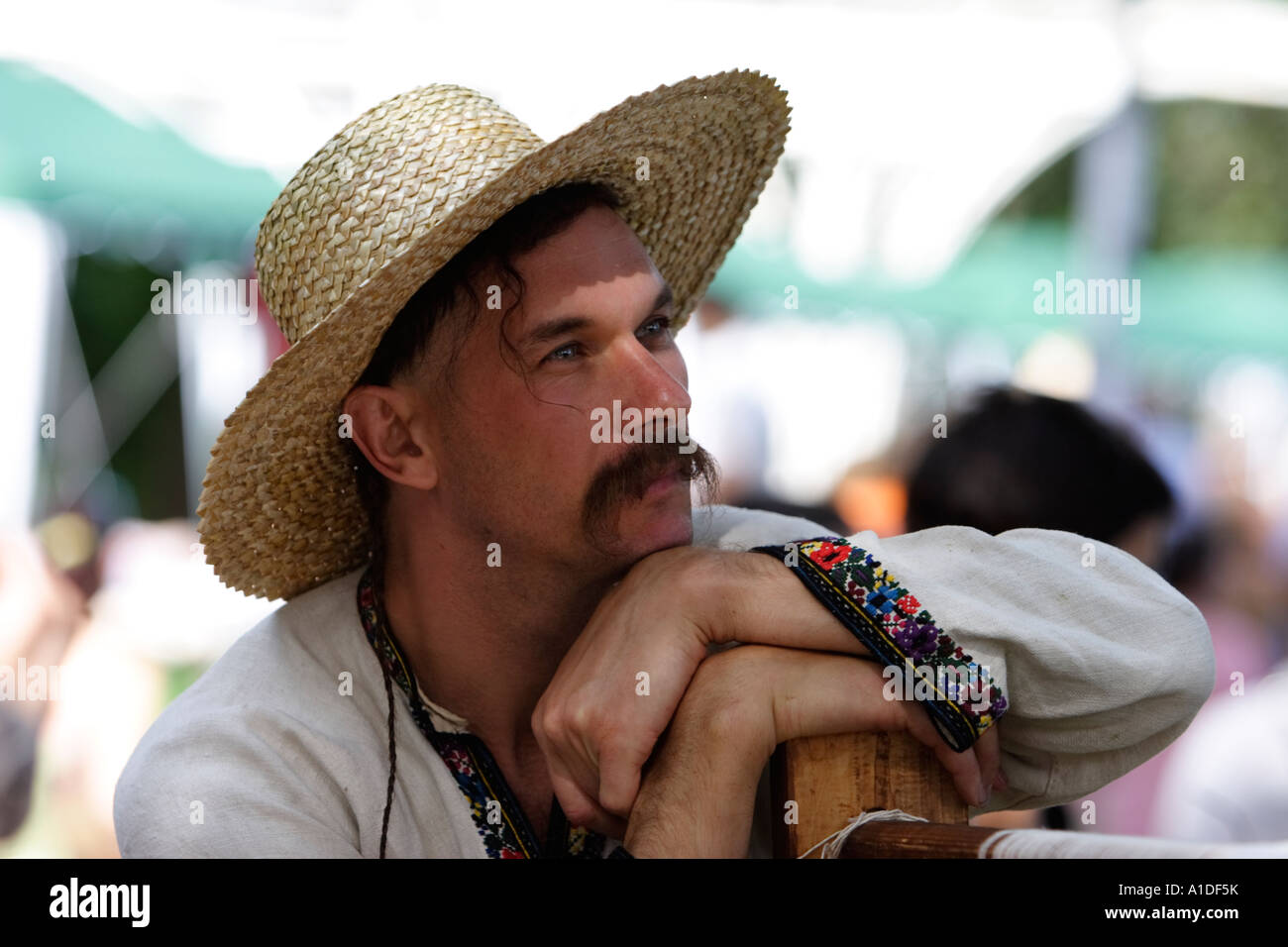 Local man in straw hat wearing ukrainian national costume during folk ...
