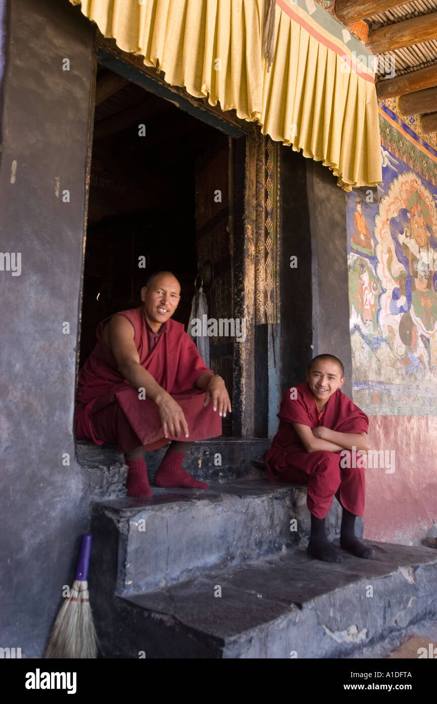 Two Buddhist monks sitting on stone steps at Thiksey Monastery in Jammu ...