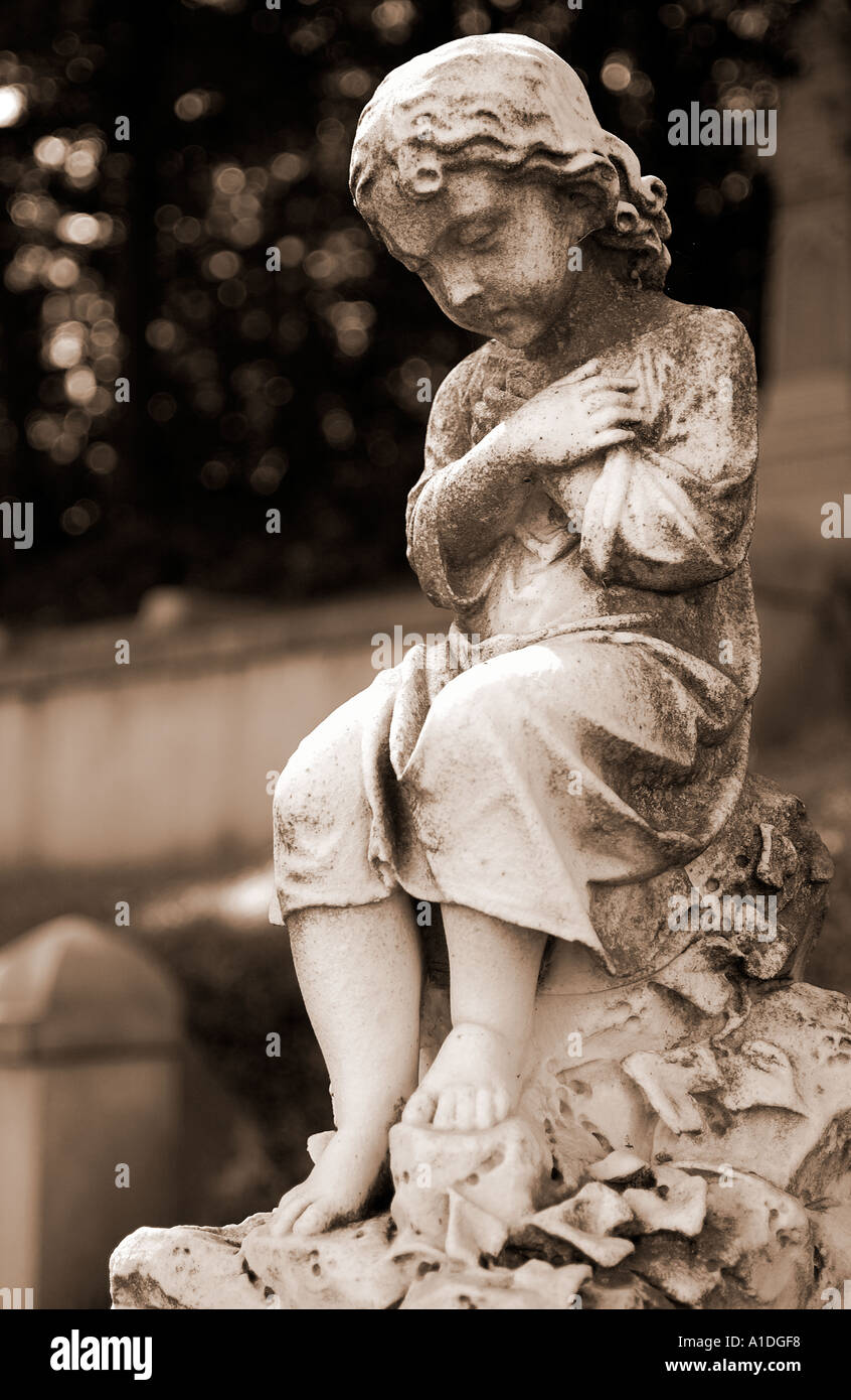 Statue of a child in a cemetery Stock Photo - Alamy