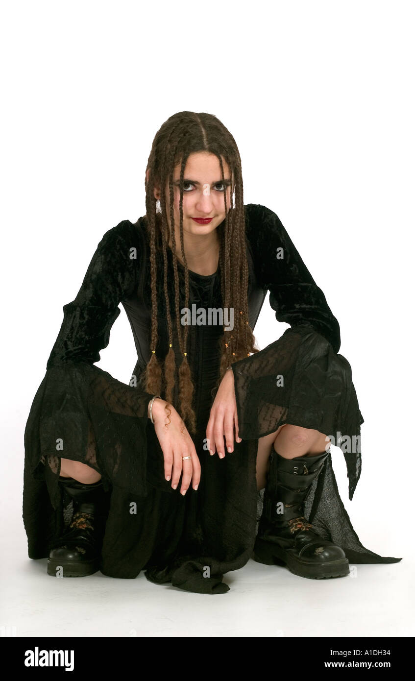 Studio portrait of a goth girl crouching on a white background Stock ...