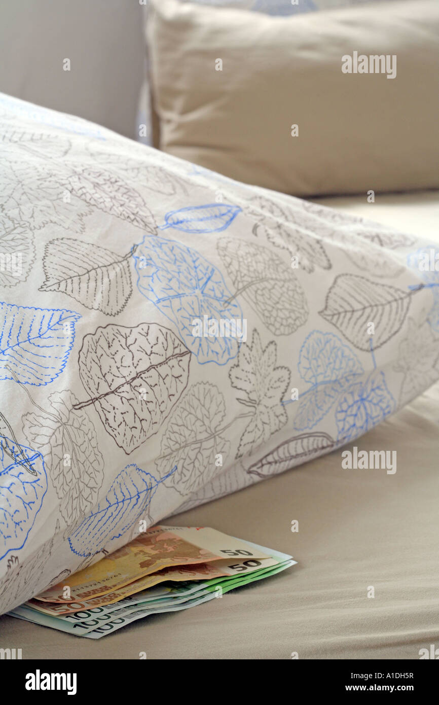 Money hiding place under the pillow Stock Photo - Alamy