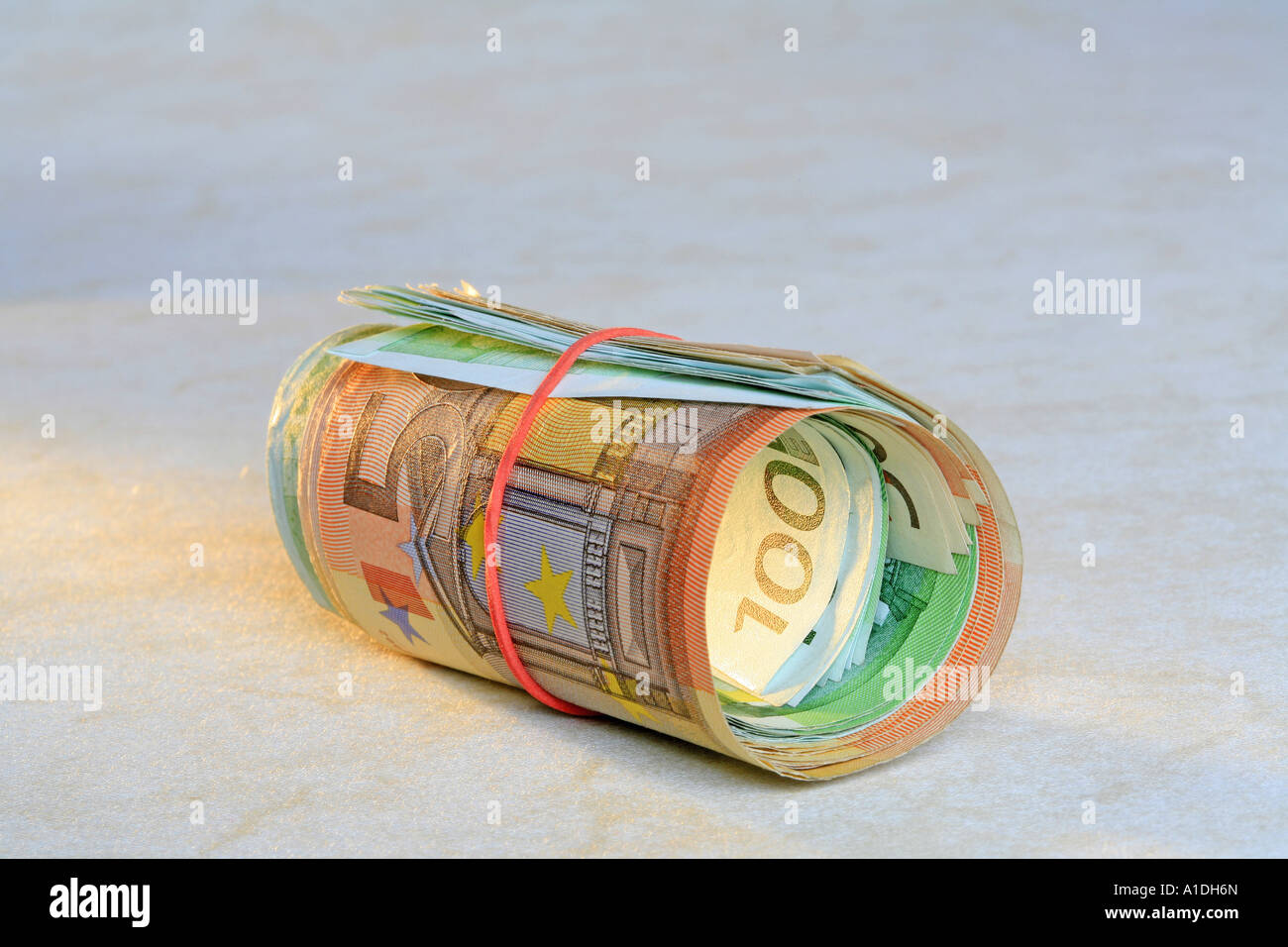 Rolled Euro bank notes with a rubber ring Stock Photo - Alamy
