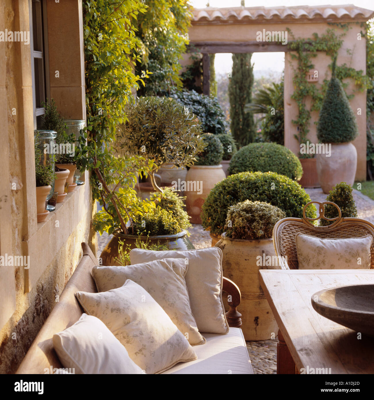 Villa terrace with bench and terracotta pots, Mallorca Stock Photo - Alamy