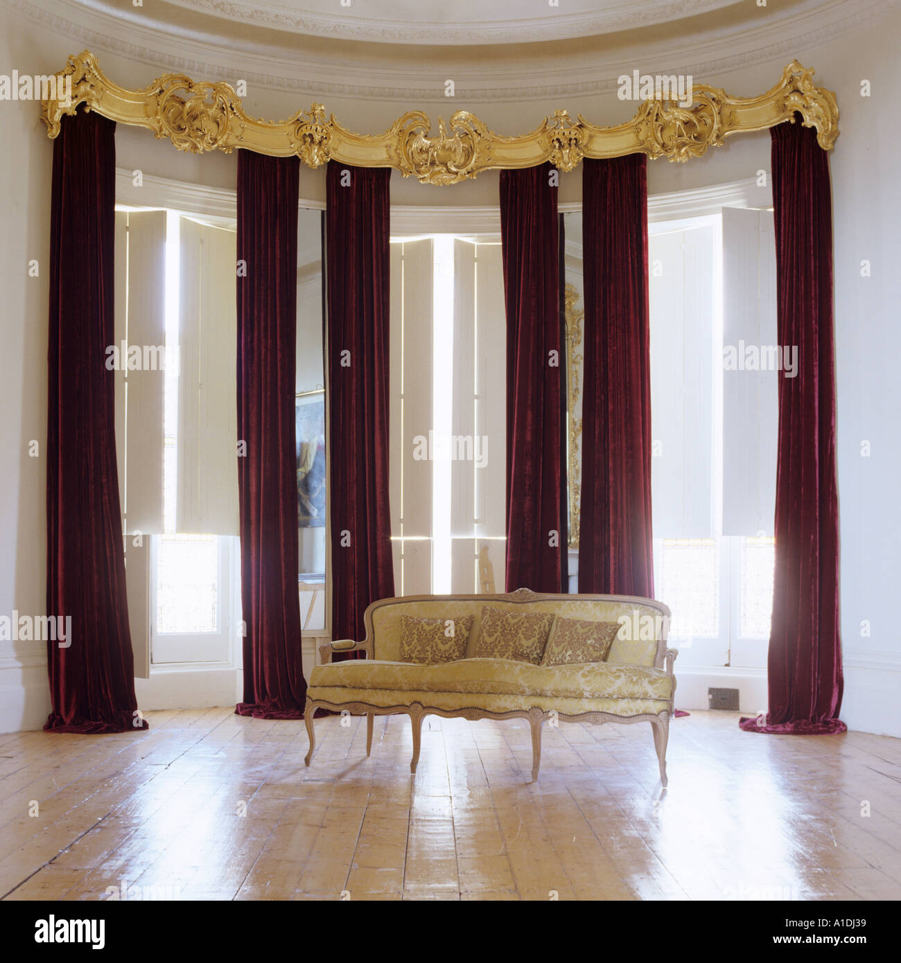 Curved reception room with bay window and settee Stock Photo - Alamy