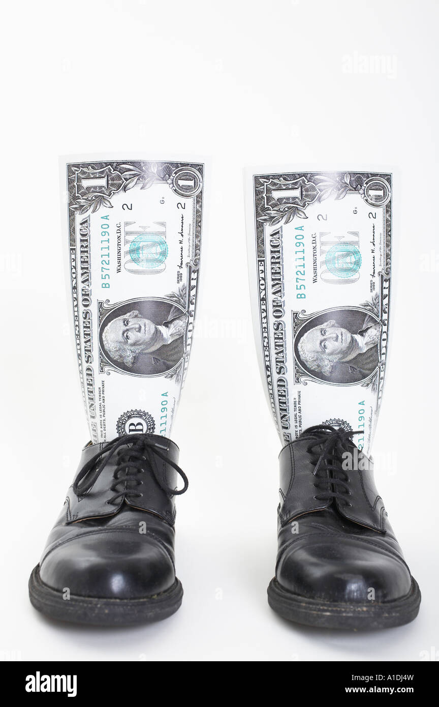Shoes with dollars Stock Photo - Alamy