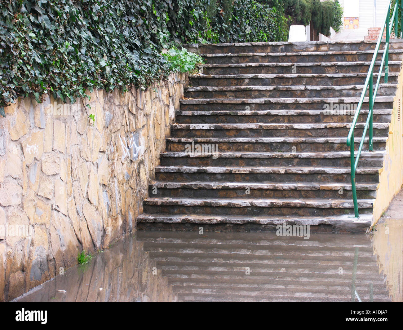Water at bottom of steps in urban setting Stock Photo - Alamy