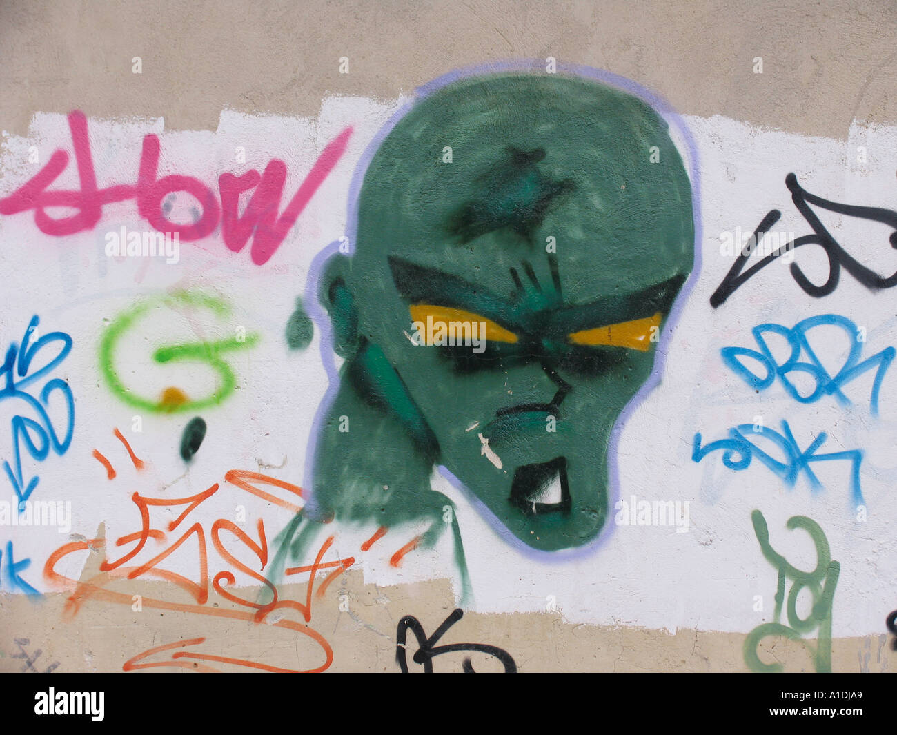 Graffiti of head and letters on urban wall Stock Photo - Alamy