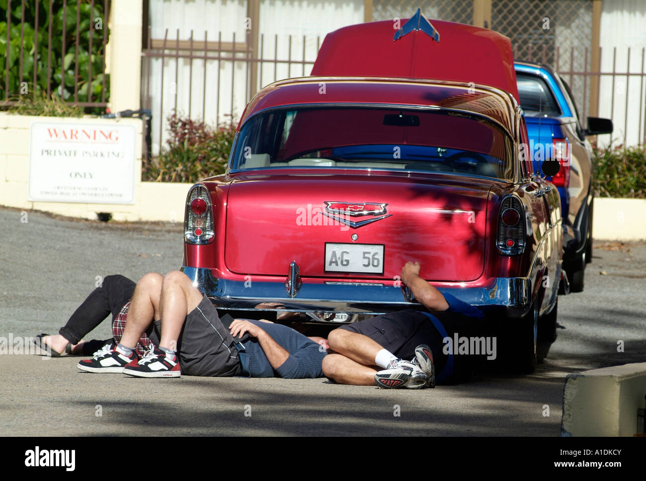 Friends helping fix the car. photo by Bruce Miller Stock Photo - Alamy
