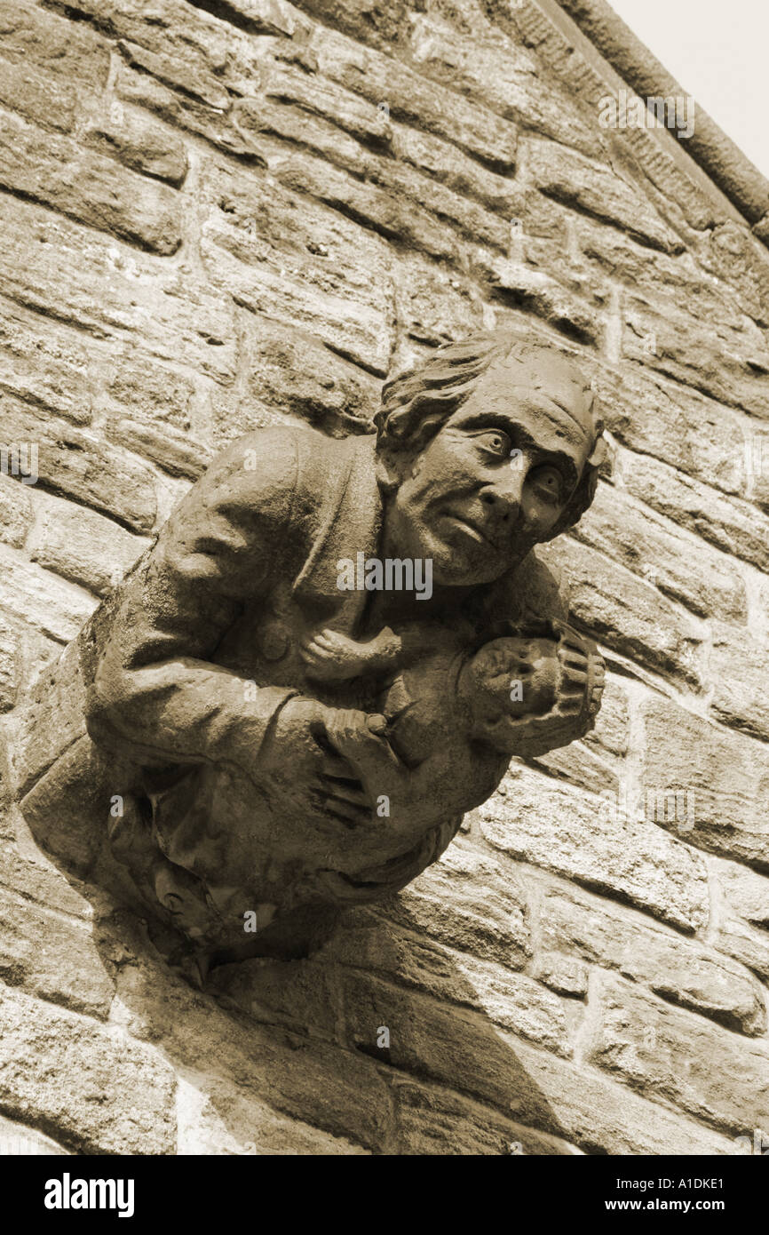 Dickensian gargoyle showing Victorian man holding young baby Saint ...