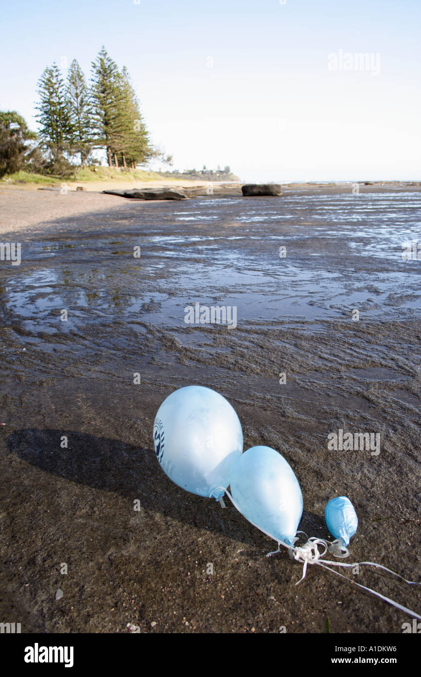 PARTIALLY DEFLATED BALLOONS ON ROCKS AT A BEACH Stock Photo - Alamy