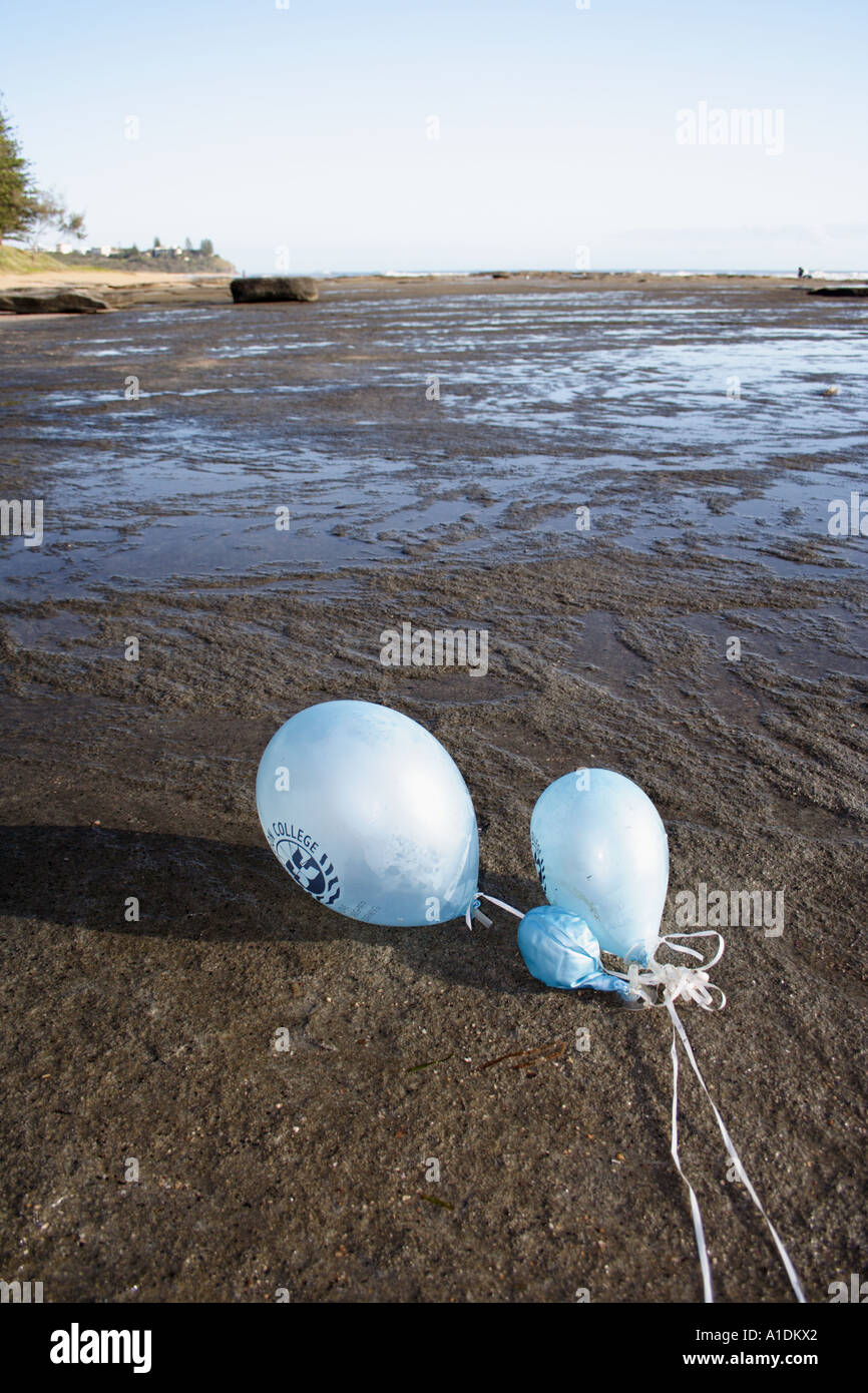 PARTIALLY DEFLATED BALLOONS ON ROCKS AT A BEACH Stock Photo - Alamy