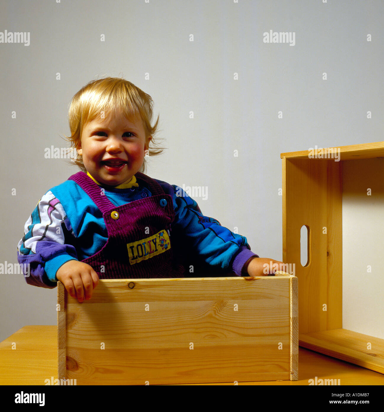 child playing with wooden box. Photo by Willy Matheisl Stock Photo - Alamy