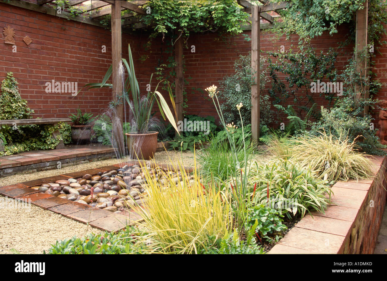 dry pool with pebbles and fountain in courtyard Stock Photo - Alamy