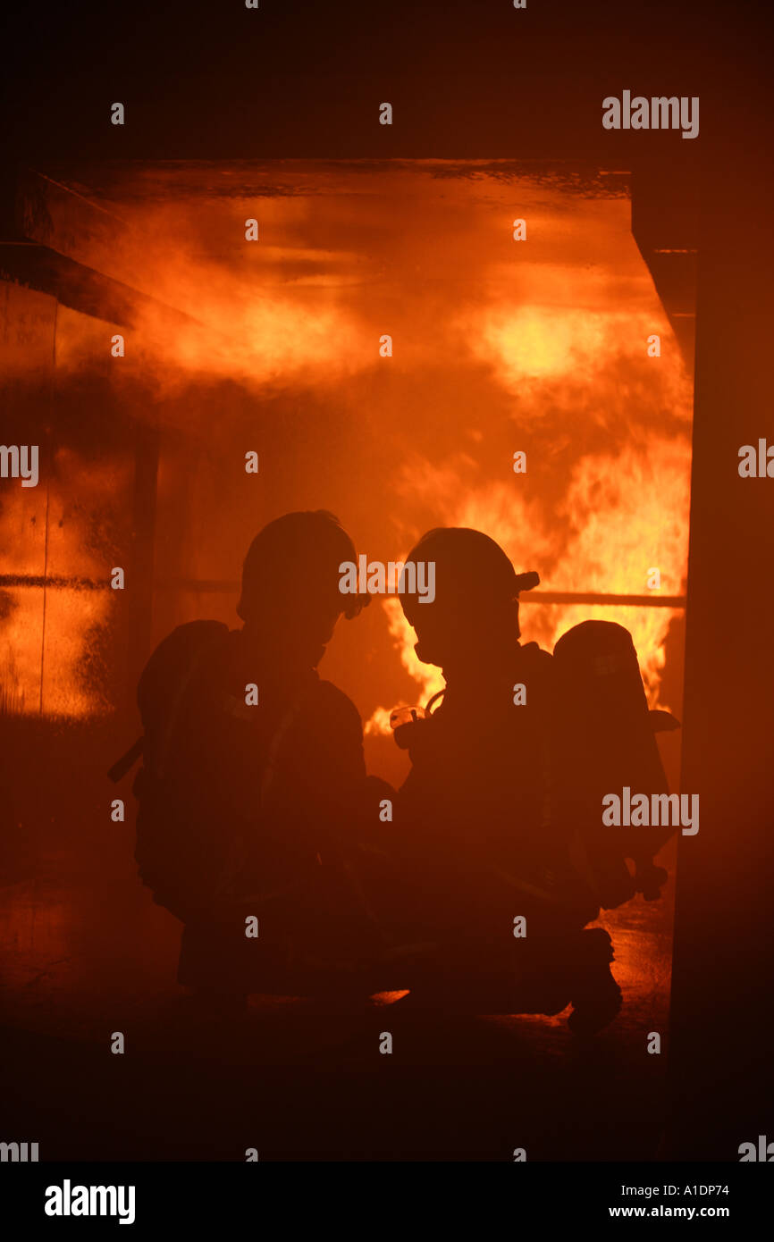 Fire fighters amoungest the flames fighting a fire Stock Photo - Alamy