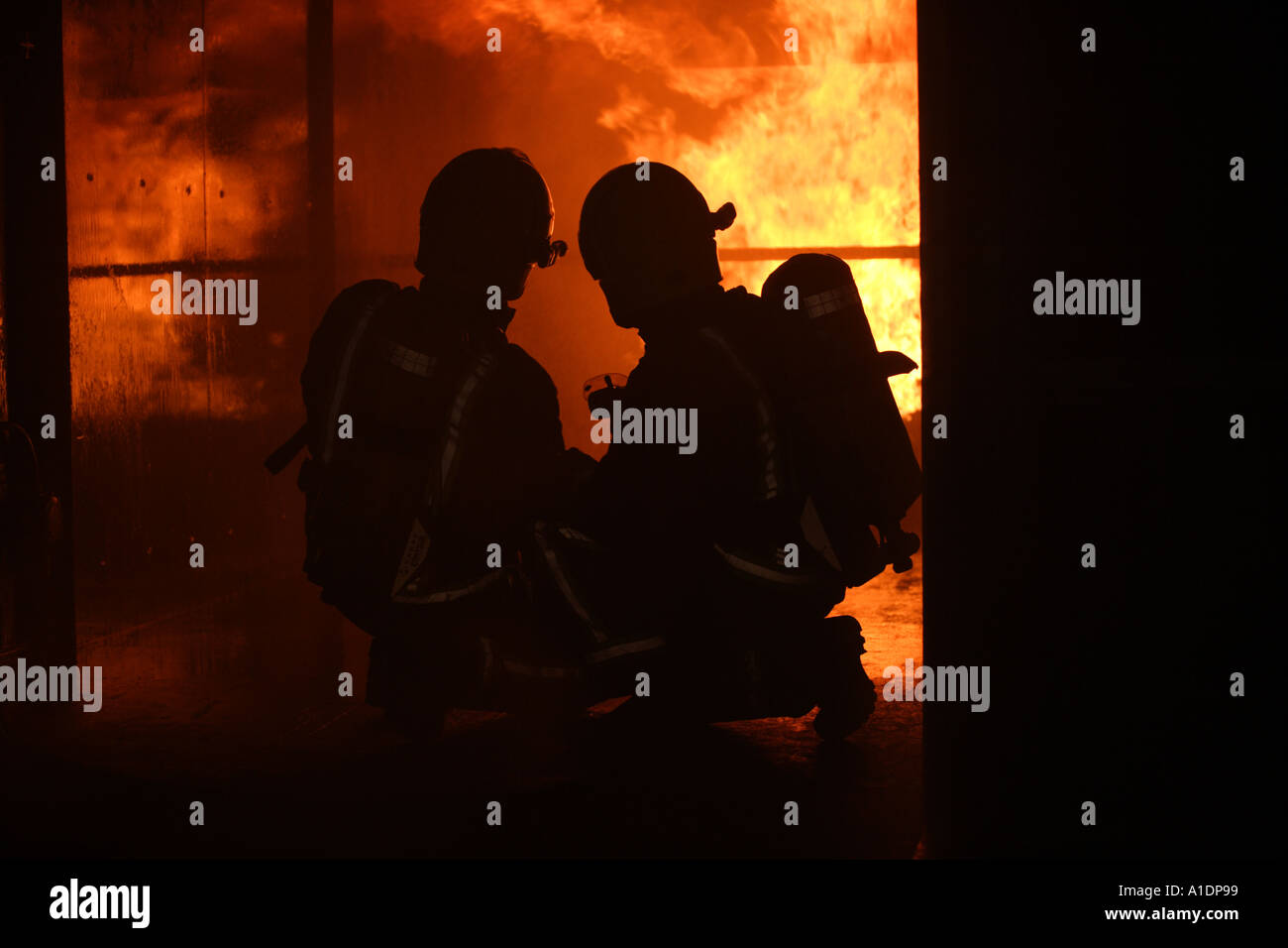 Fire fighters fighting a fire Stock Photo - Alamy