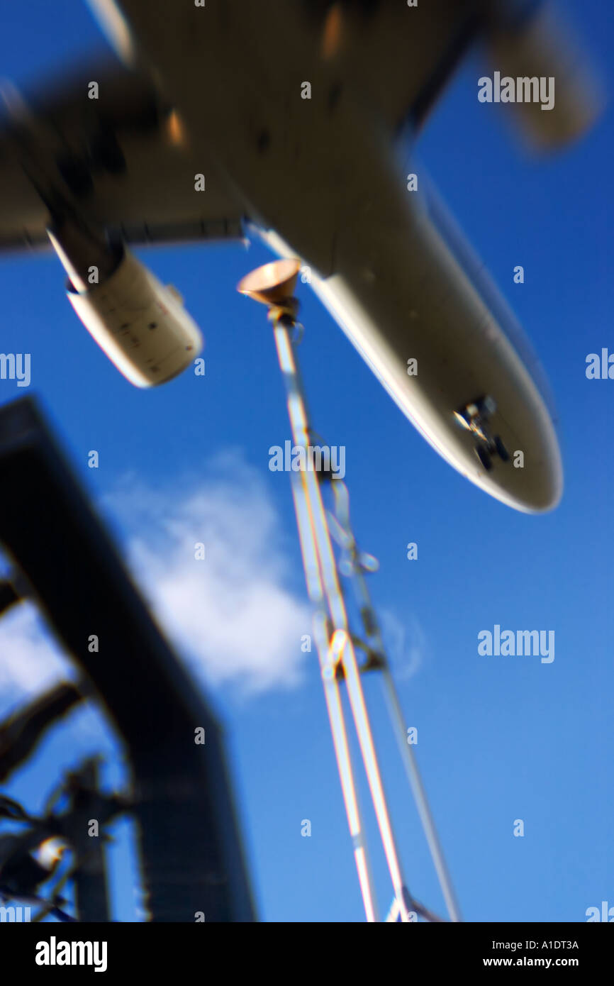 graphic image of aircraft from below with vivid, saturated blue sky ...