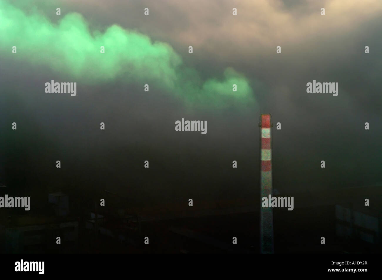 Factory chimney pouring green poisonous smoke exhalates in grey smog ...