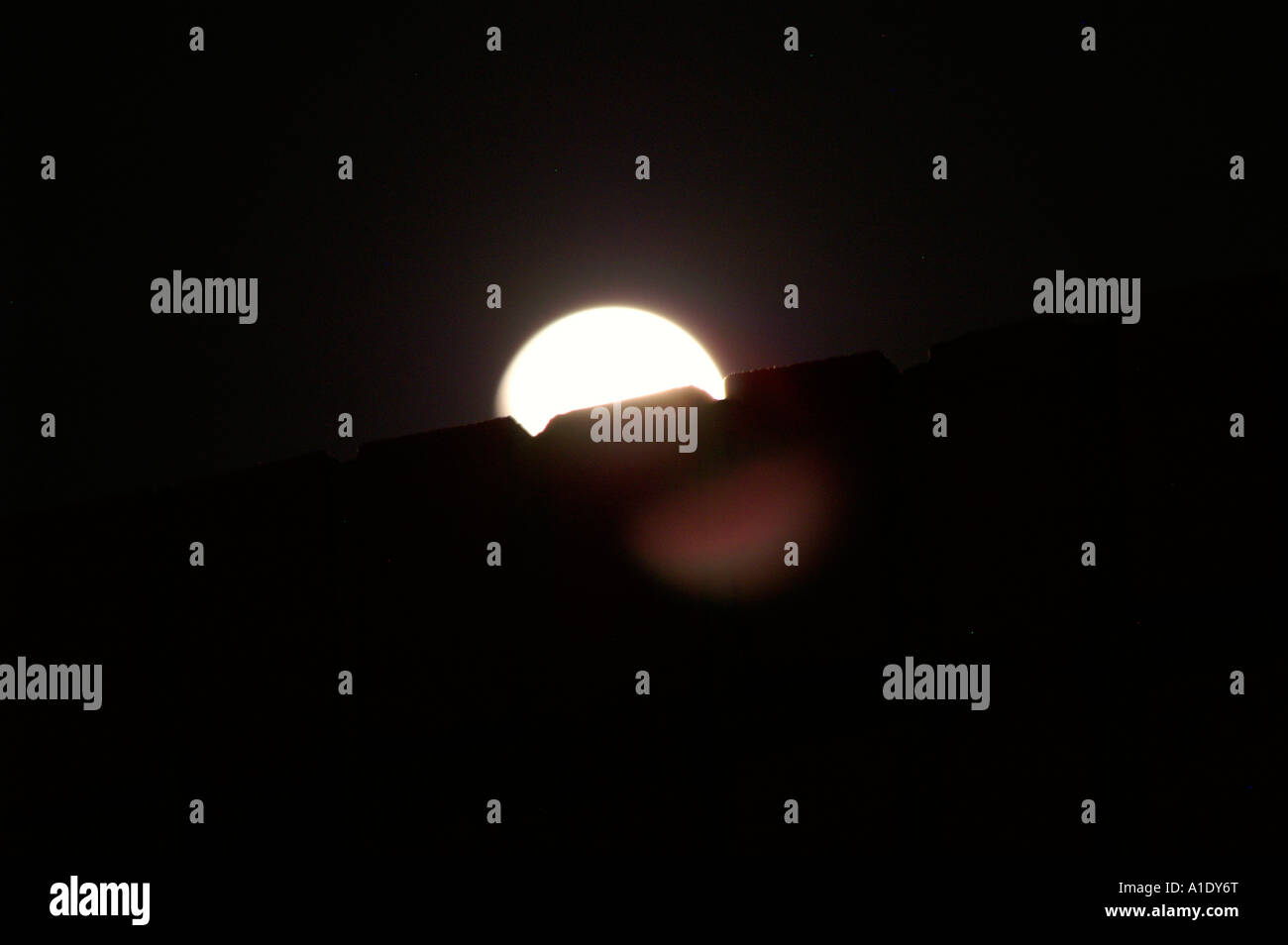 Moon rising over brick wall, night shot Stock Photo - Alamy