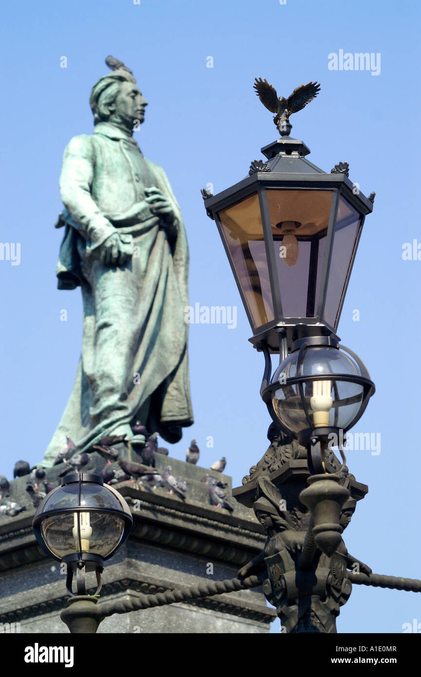 Adam Mickiewicz statue at Rynek Glowny main square Krakow on blue sky ...