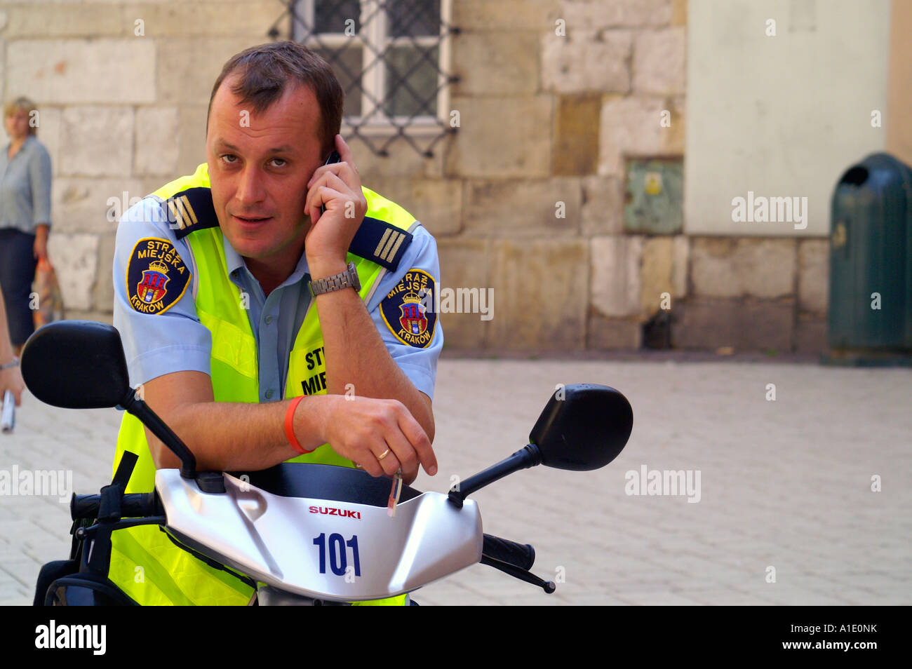 Polish policeman police officer in hi vis uniform with motorbike in old ...
