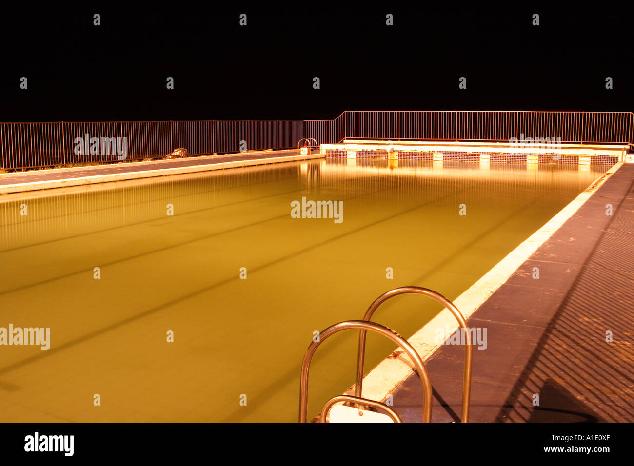 NIGHT VIEW OF AN OCEAN FED SWIMMING POOL Stock Photo - Alamy