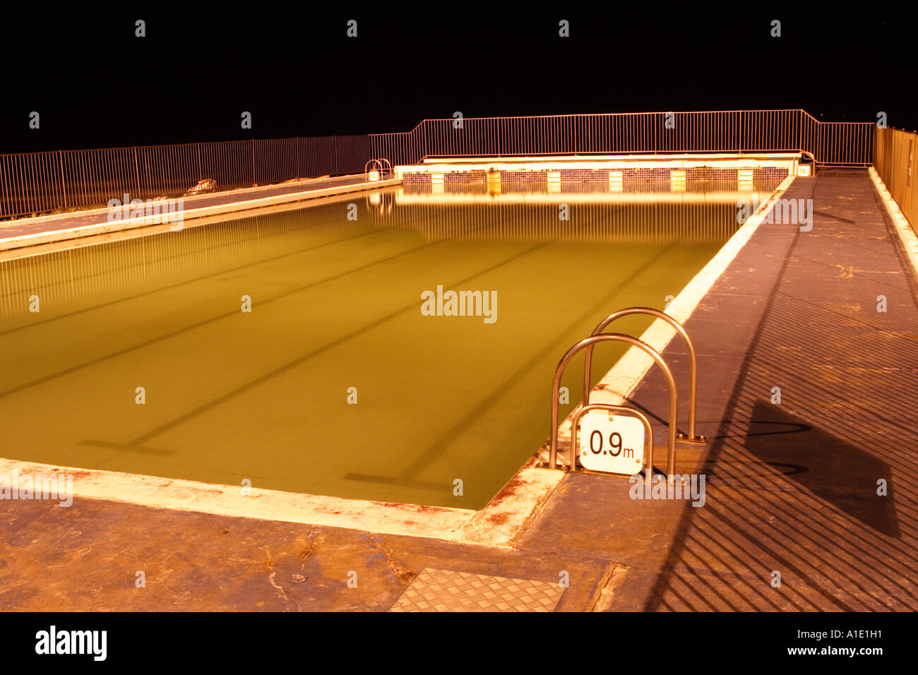 NIGHT VIEW OF AN OCEAN FED SWIMMING POOL Stock Photo - Alamy