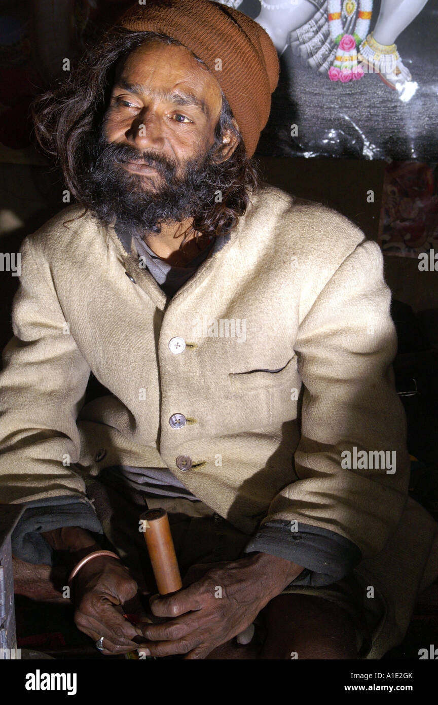 Old impoverished local indian shepherd man smoking hashish pipe in his ...