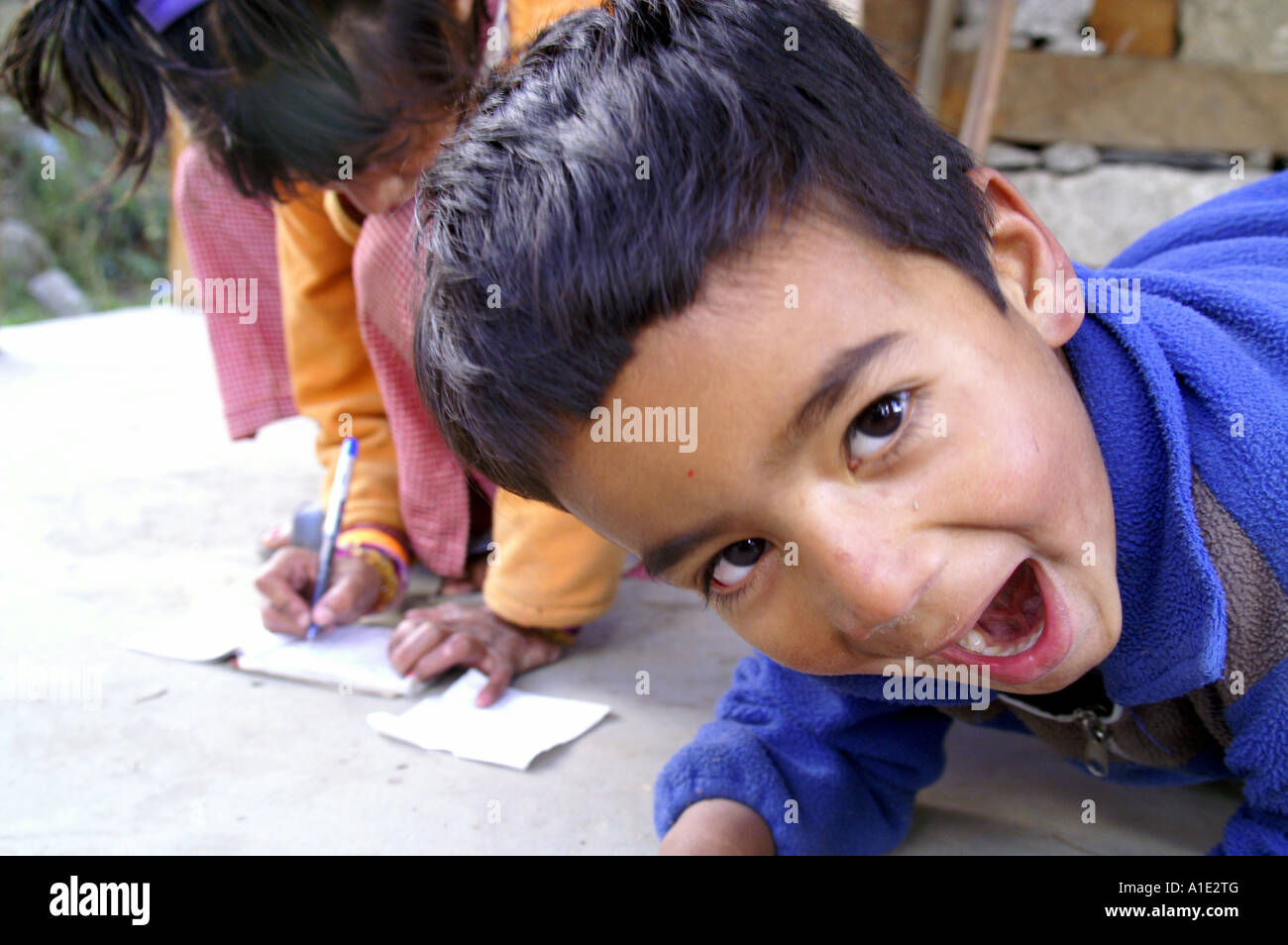 Young native indian girl child writing notes in indian alphabet into ...