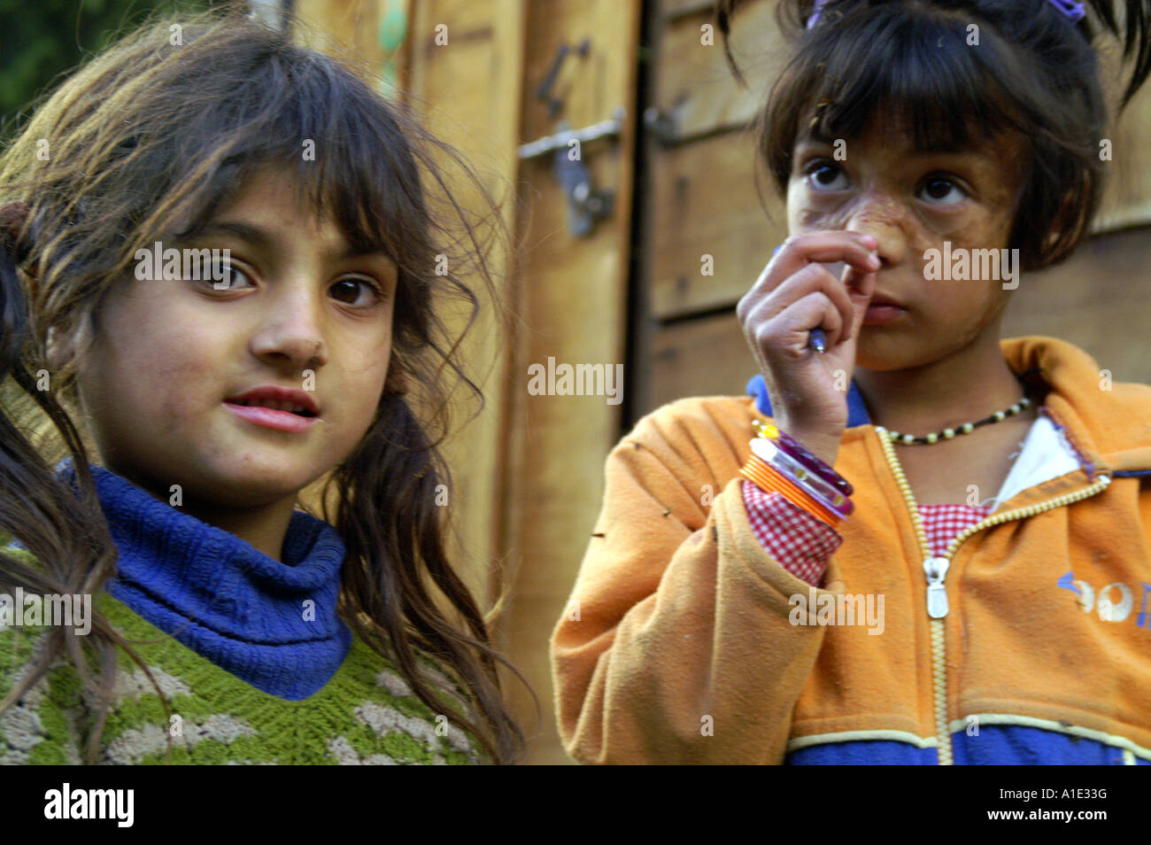 Two young native indian children girls digging nose outdoors, Kalga ...