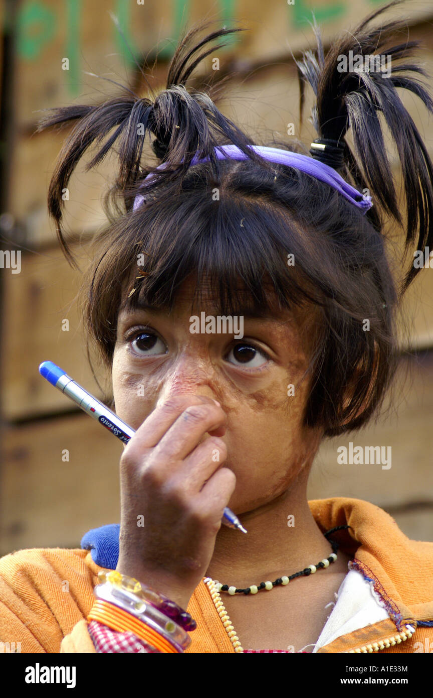 One young native indian child girl digging nose outdoors, Kalga village ...