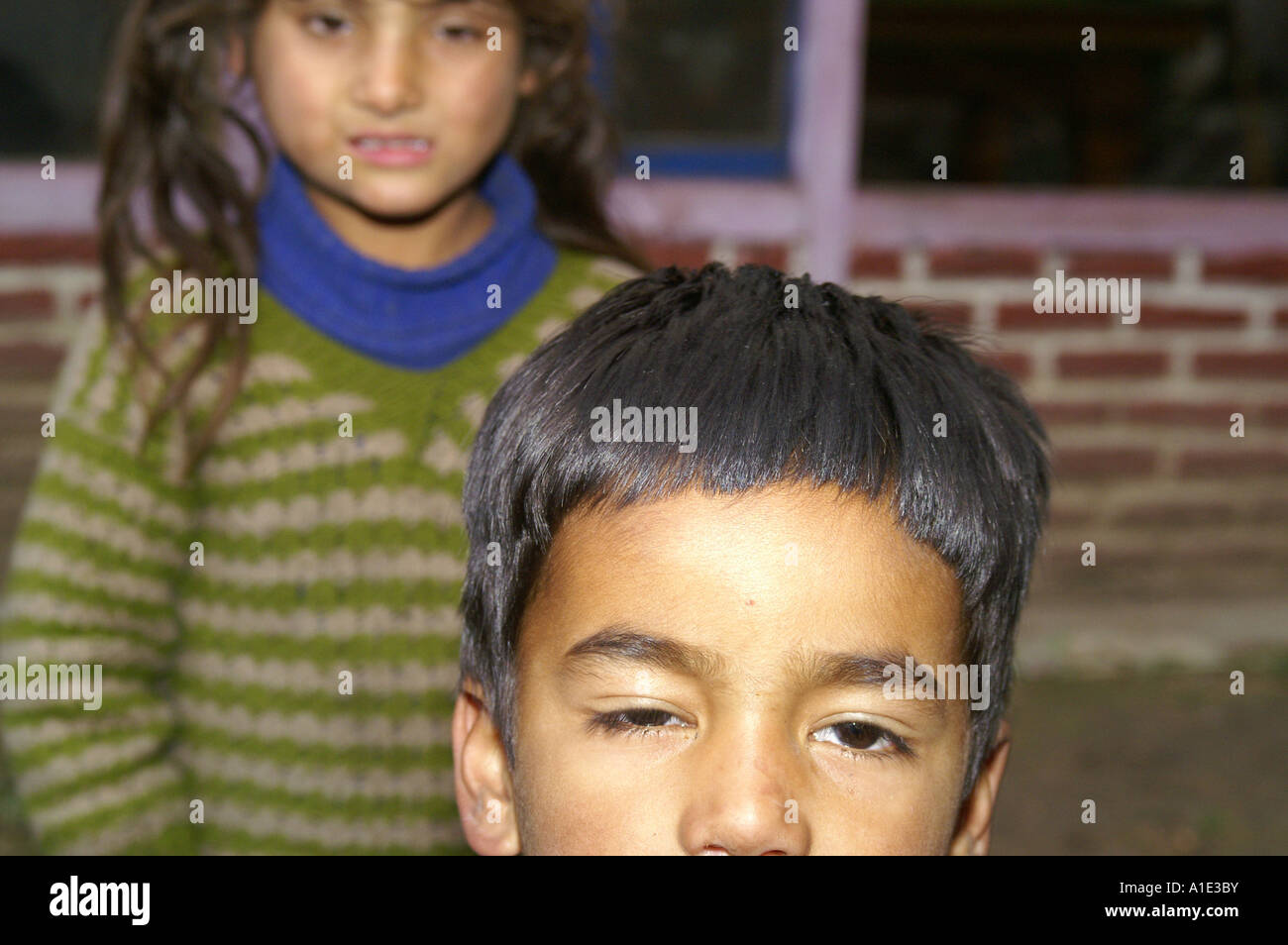 Face portrait of drowsy young indian native kid boy with girl child in ...