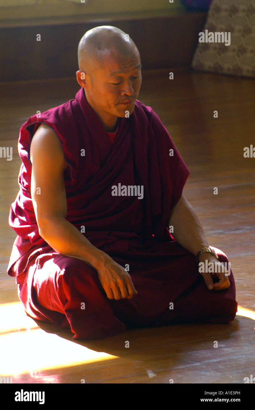 Meditating sitting buddhist tibetan monk in traditional ceremonial robe ...