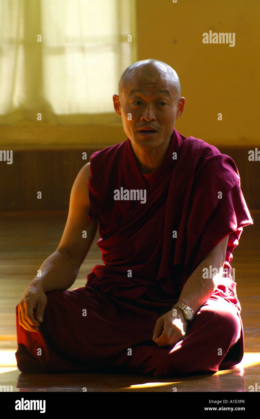 Meditating sitting buddhist tibetan monk in traditional ceremonial robe ...