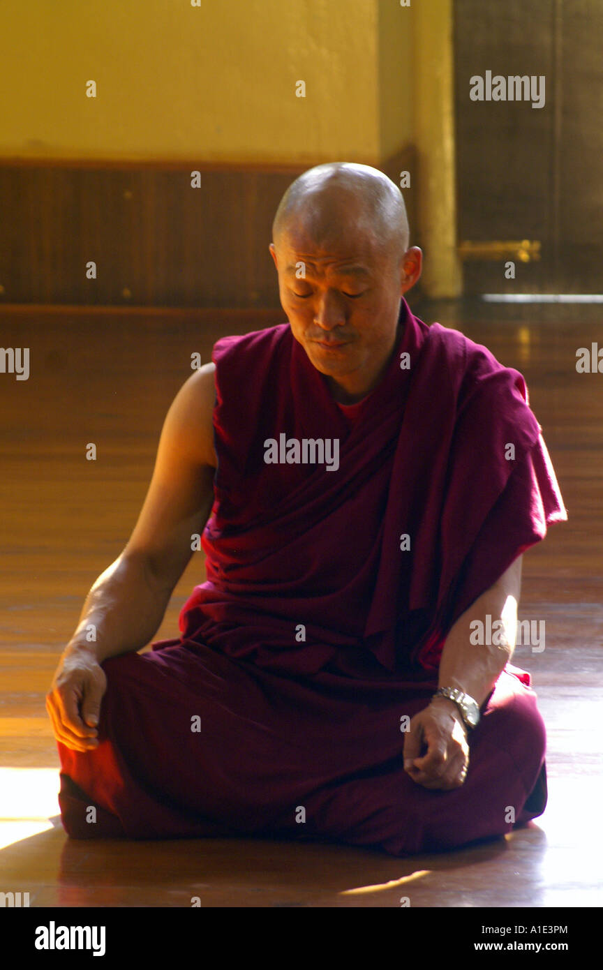 Meditating sitting buddhist tibetan monk in traditional ceremonial robe ...