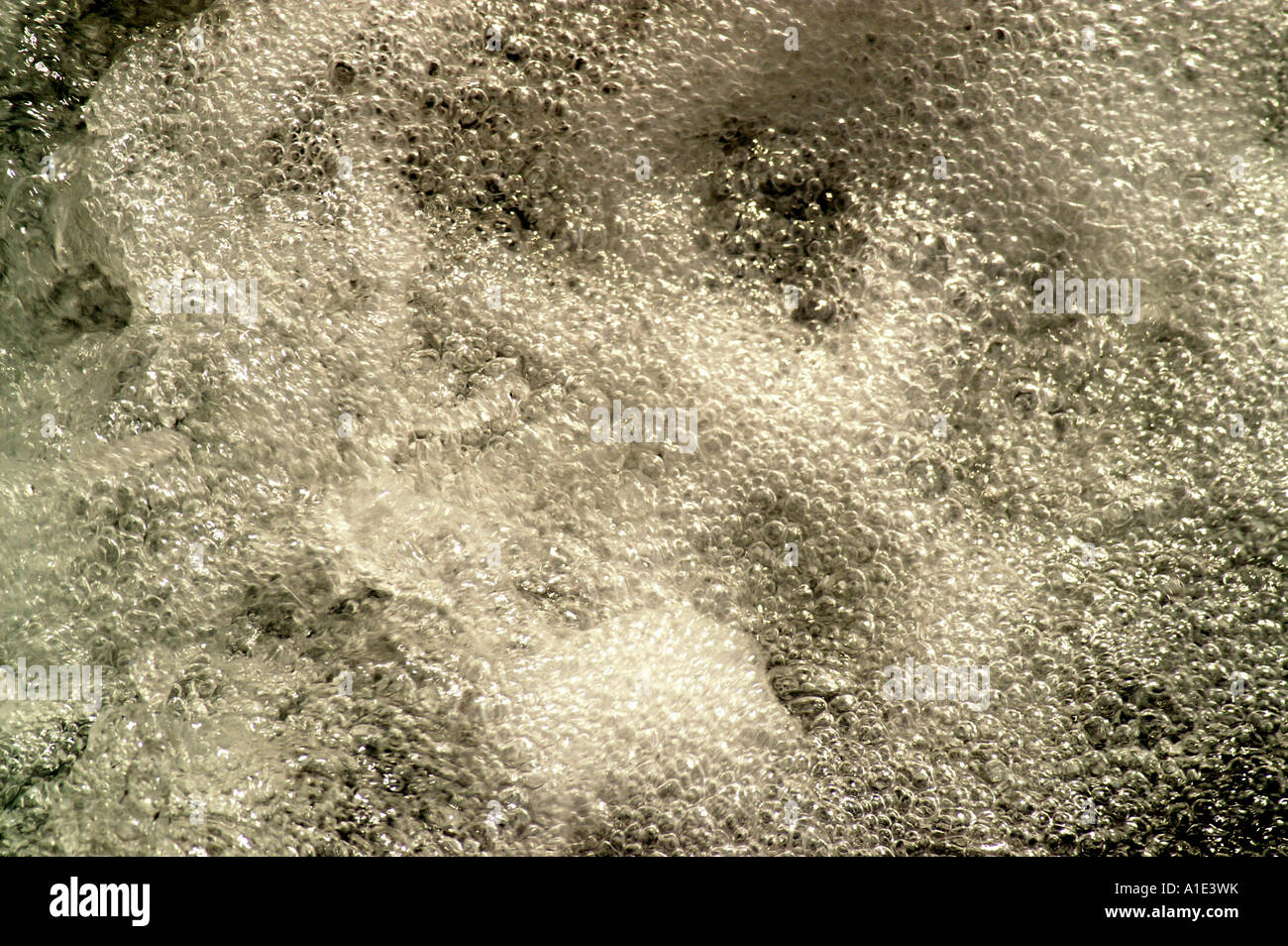 Bubbles on water surface constant motion abstraction Stock Photo - Alamy