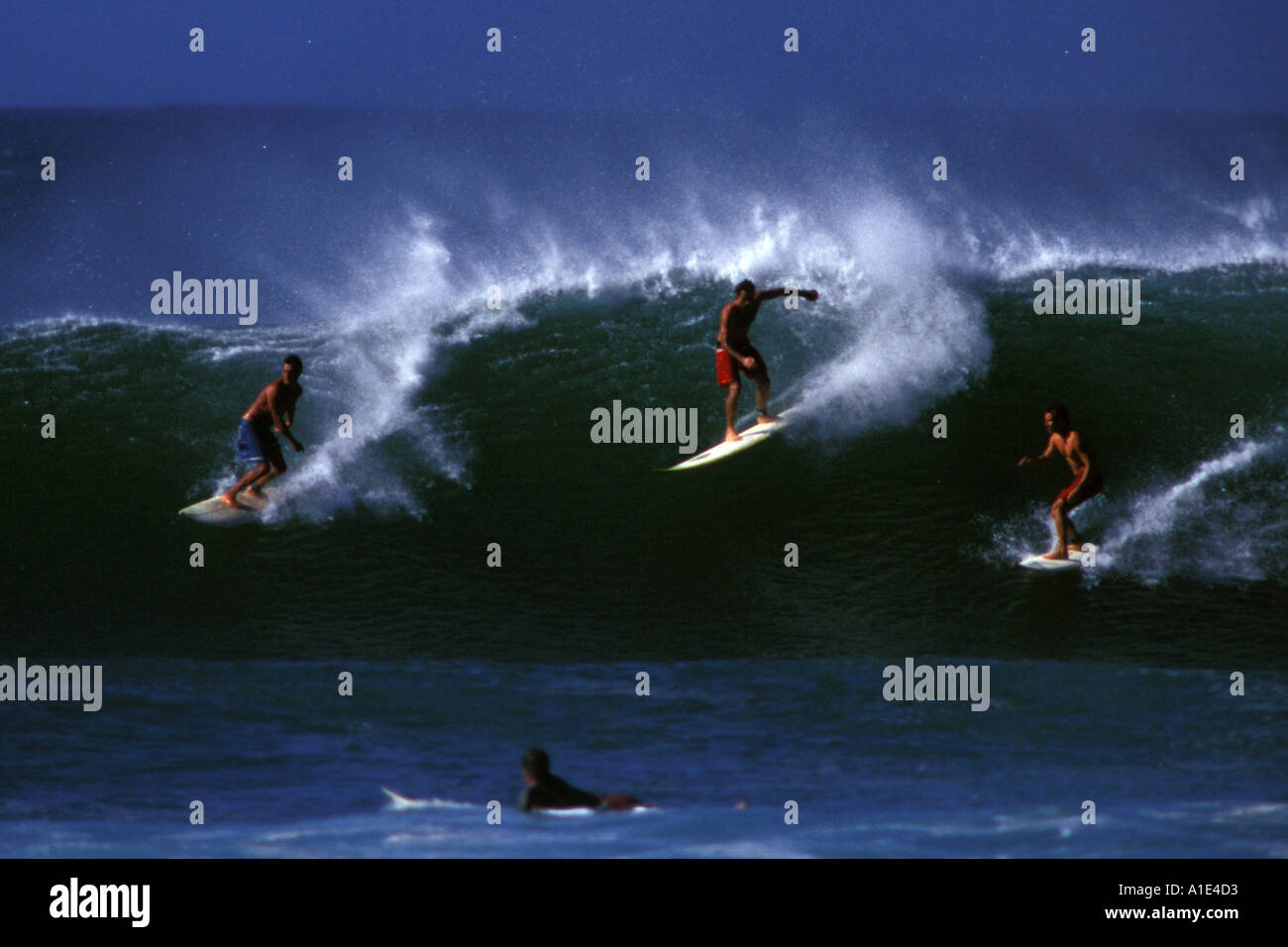 Crowded Wave at Sunset Beach Stock Photo - Alamy