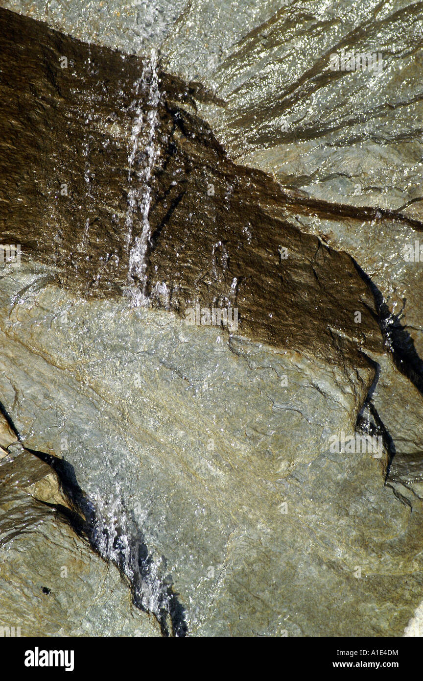 Water stream flowing dropping over stone edge Stock Photo - Alamy