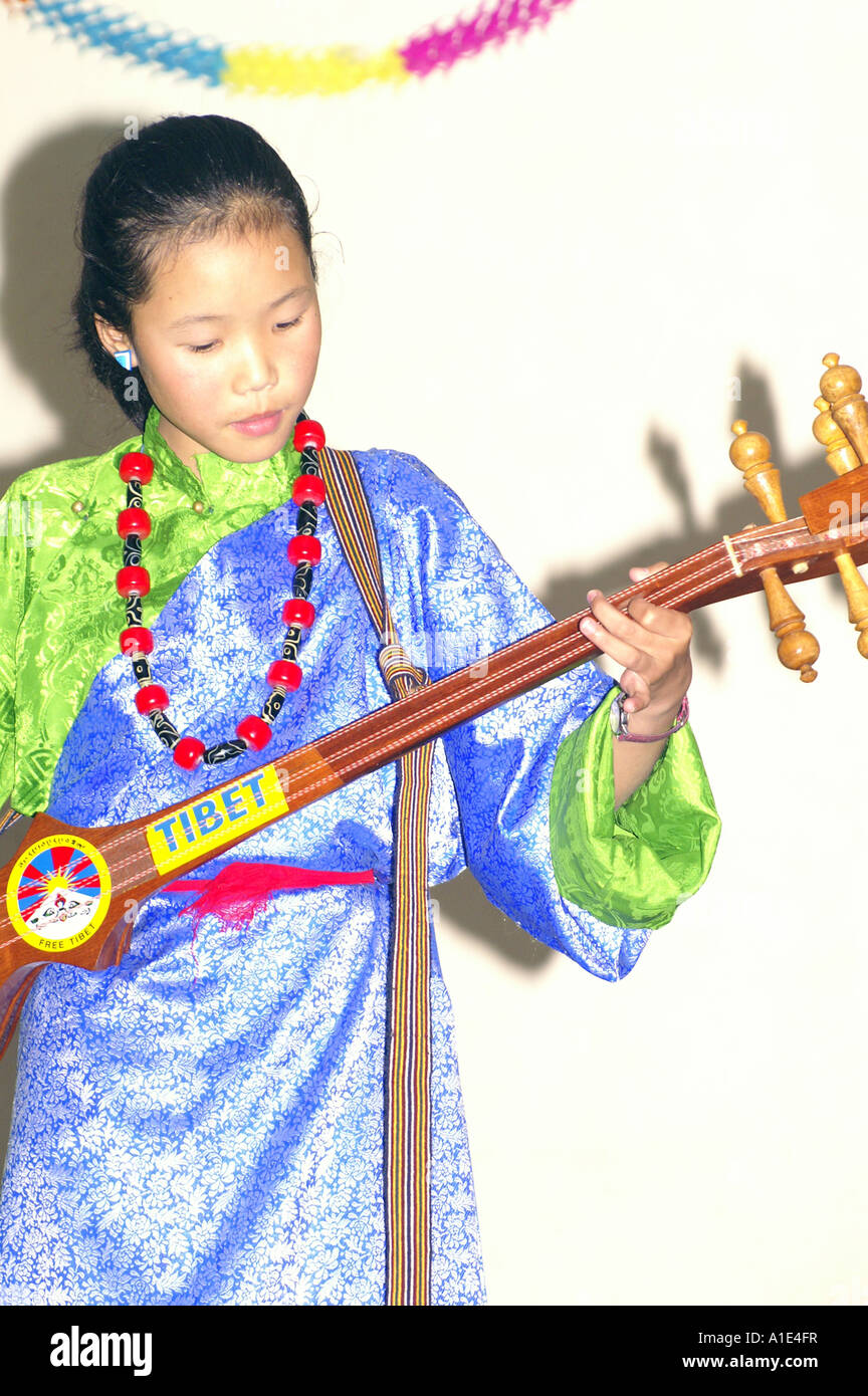 Young girl singer performer of tibetan arts music in front of white ...