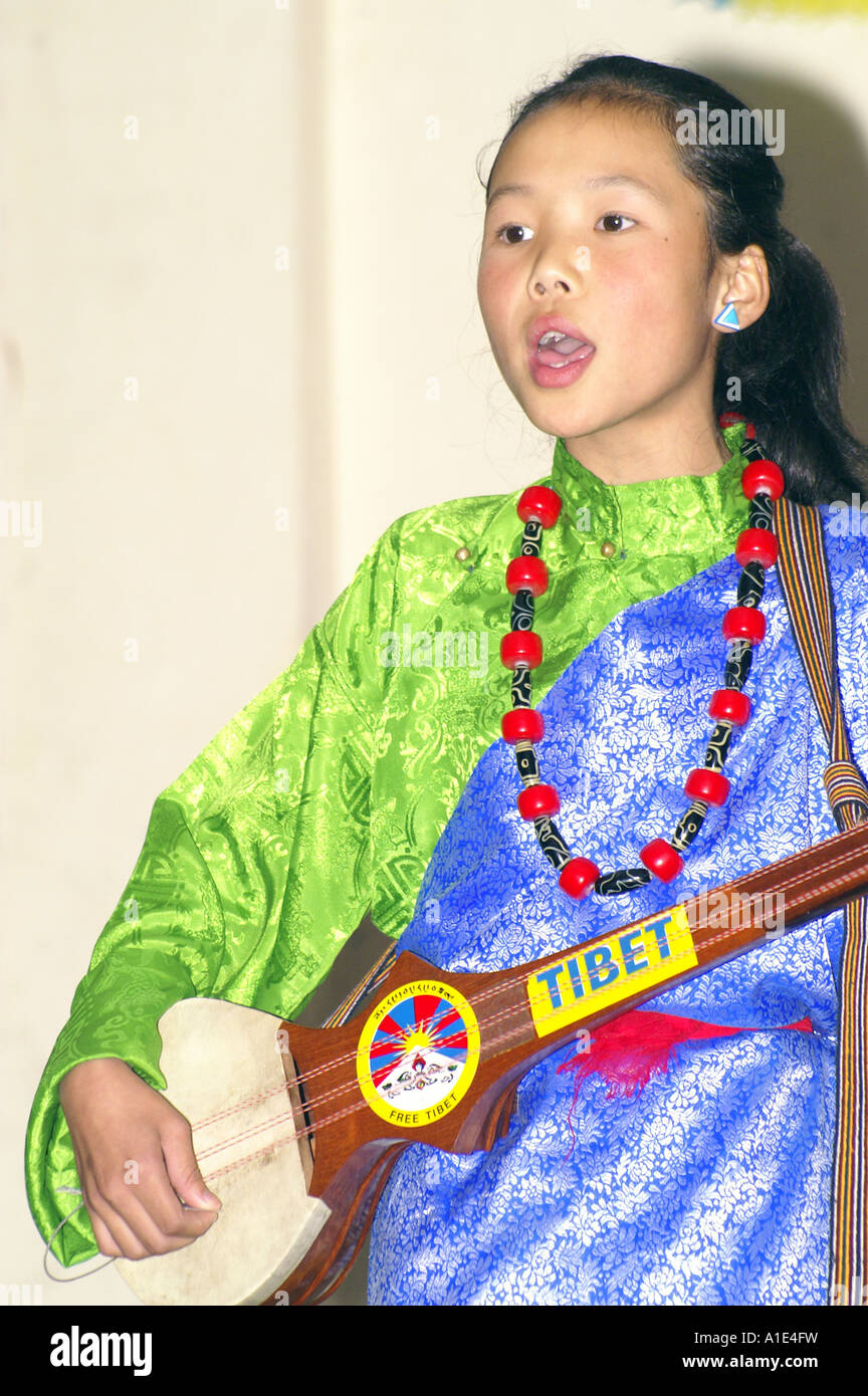 Young girl singer performer of tibetan arts music in front of white ...