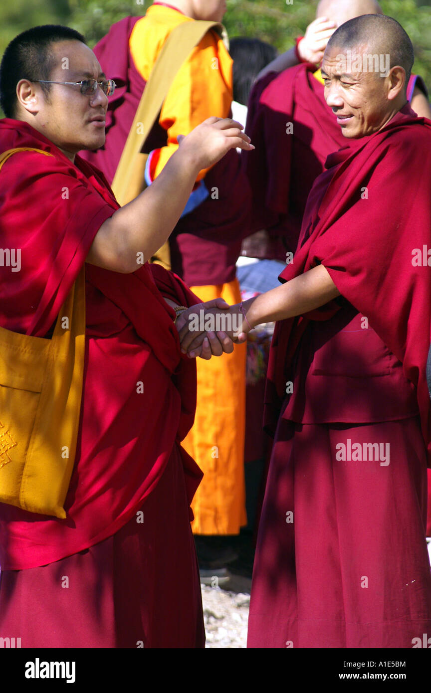 Two tibetan monks buddhists shaking hands in reaching final important ...