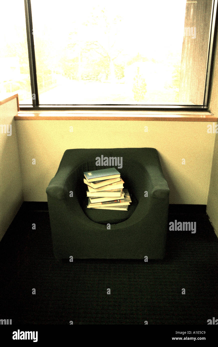 Stack of books on library chair Stock Photo - Alamy