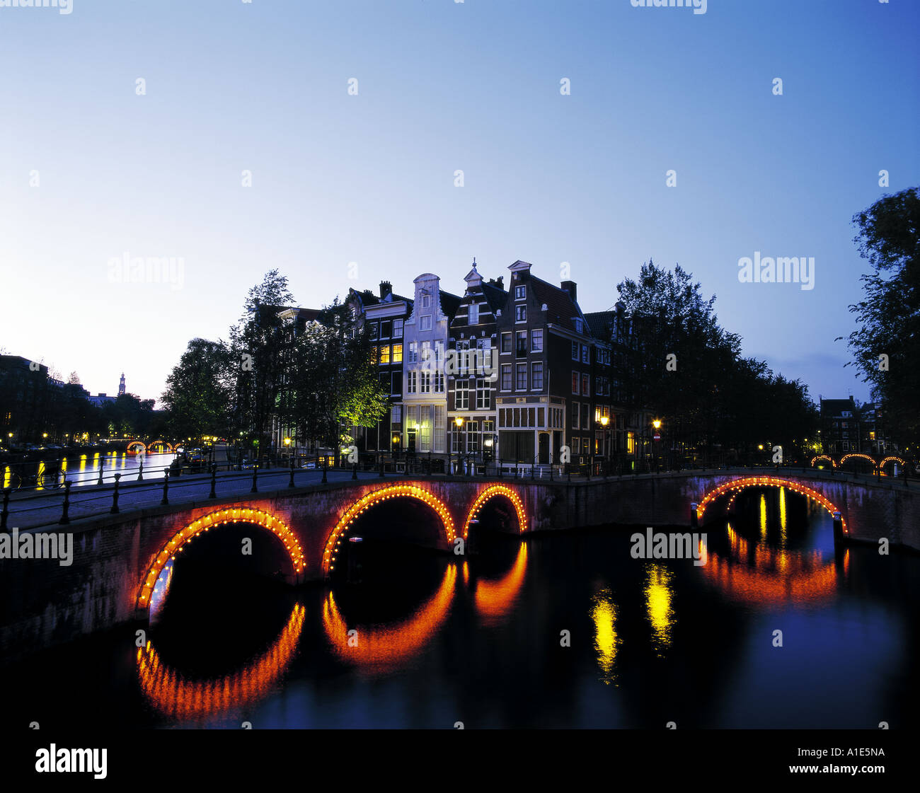 Illuminated bridges over canal in Amsterdam, Holland Stock Photo - Alamy