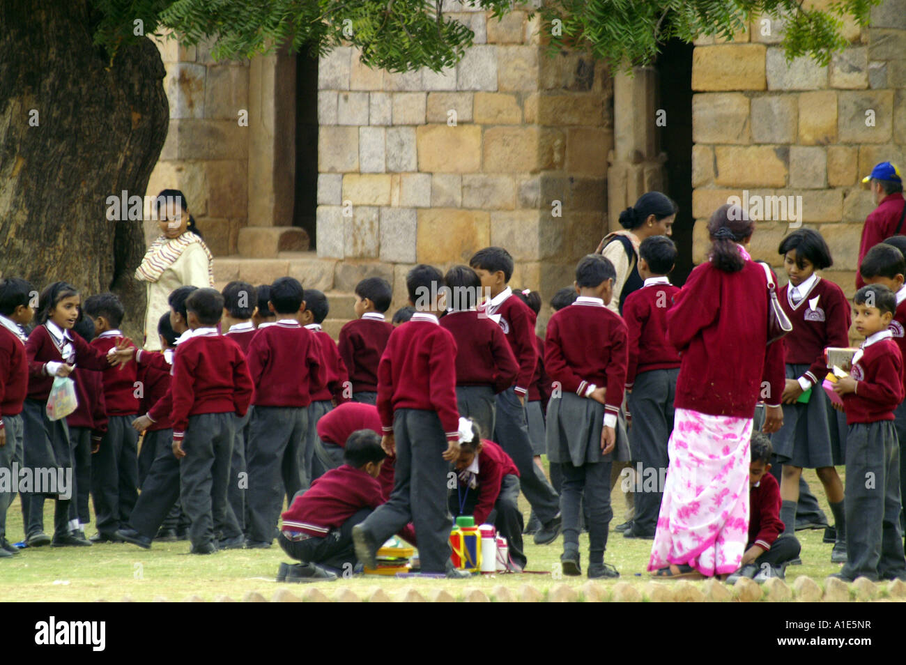 Young indian child kid girl boy school trip at Qutb Minar in New Delhi ...